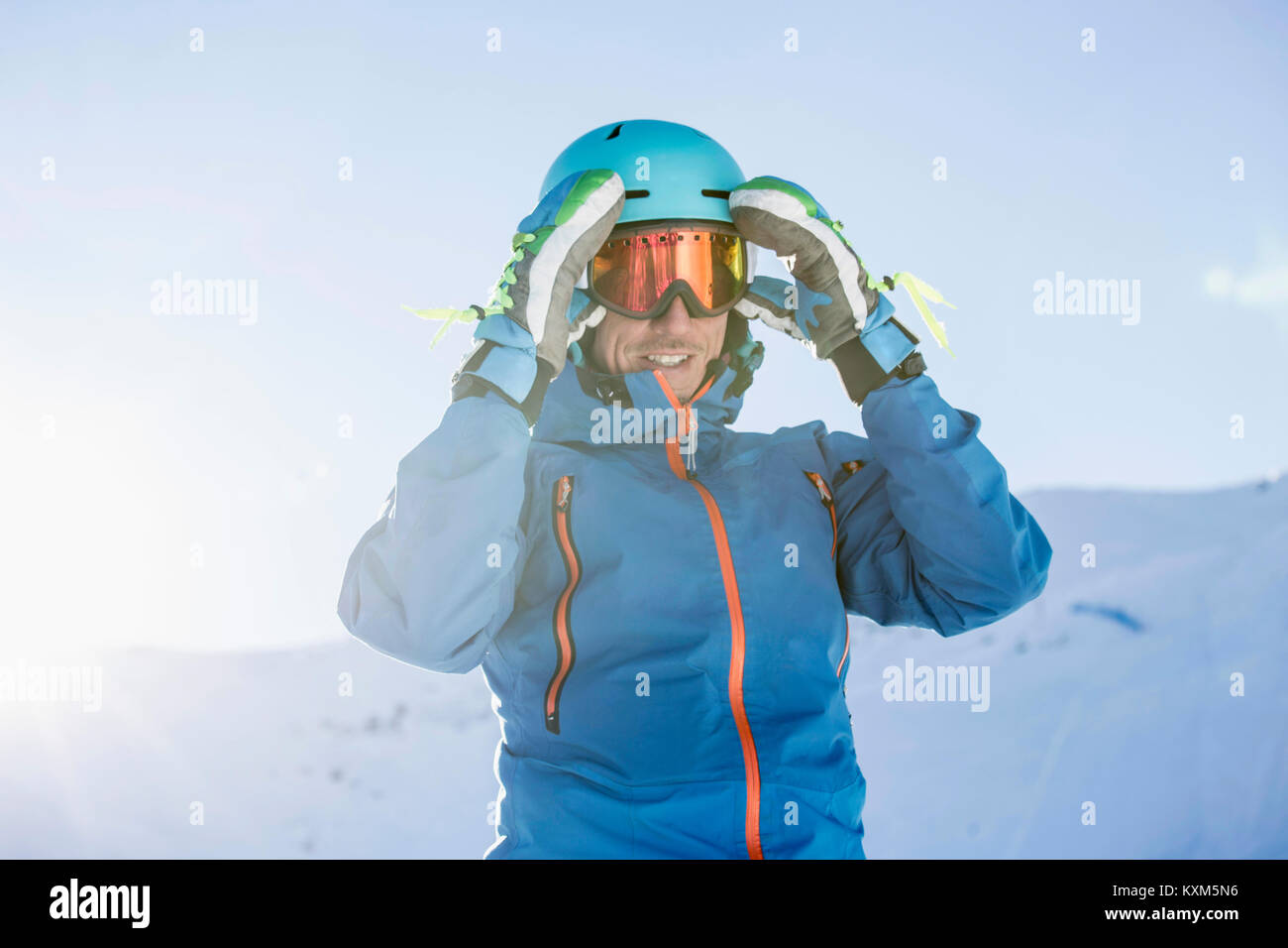 Portrait of skier,adjusting goggles Stock Photo - Alamy