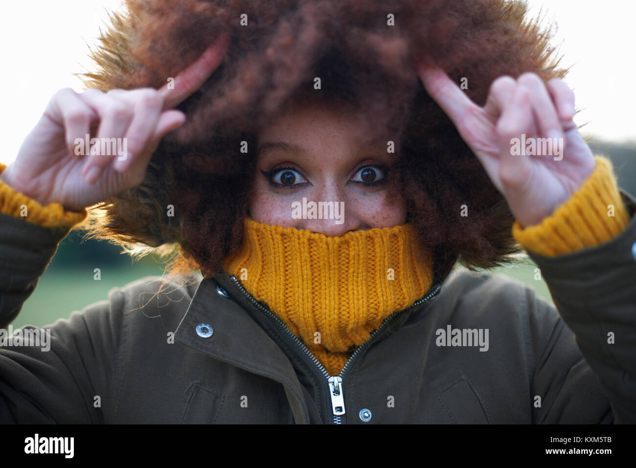 Portrait of young woman outdoors,wrapped up warm Stock Photo - Alamy