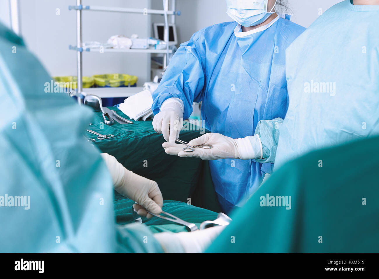 Over shoulder view of surgeon handed surgical scissors in maternity ...