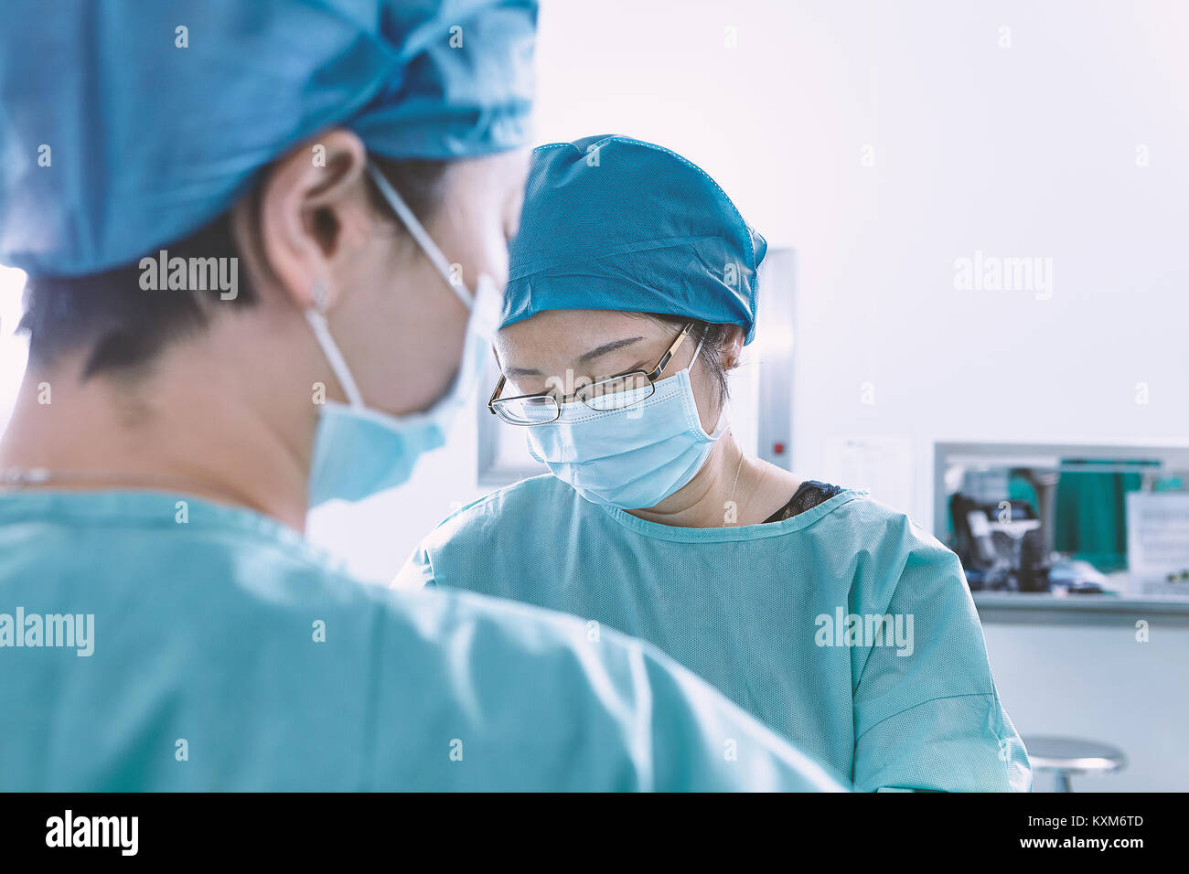 Over shoulder view of surgeon performing operation in maternity ward ...
