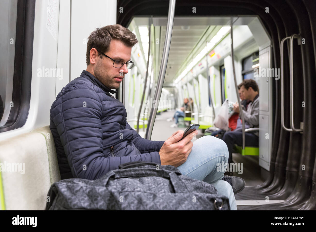Male commuter reading from hi-res stock photography and images - Alamy