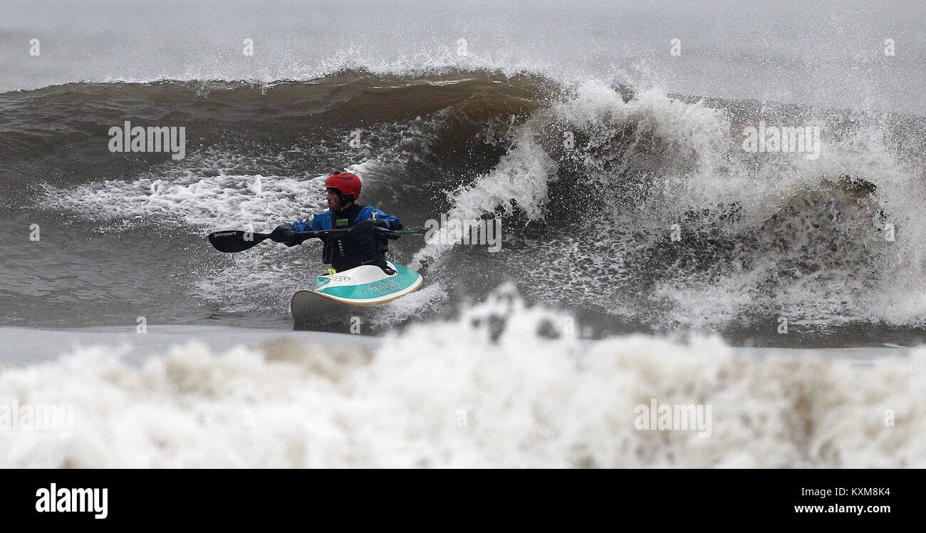 A Kayak in the waves at Tynemouth beach, Tyne and Wear in the north ...
