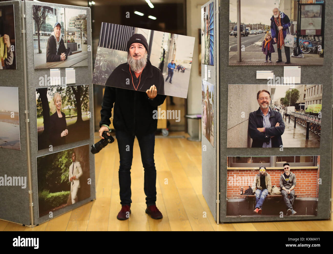 Photographer Peter Varga holding a print from his Humans of Dublin ...