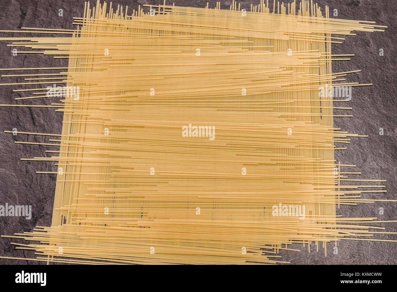Spaghetti pasta on grey working surface Stock Photo - Alamy