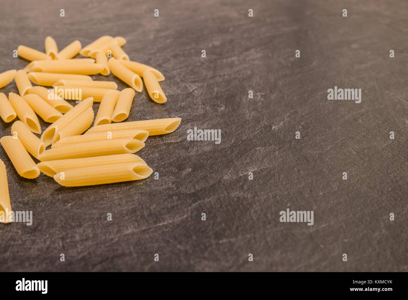 Penne Rigate macaroni pasta on grey working surface Stock Photo - Alamy