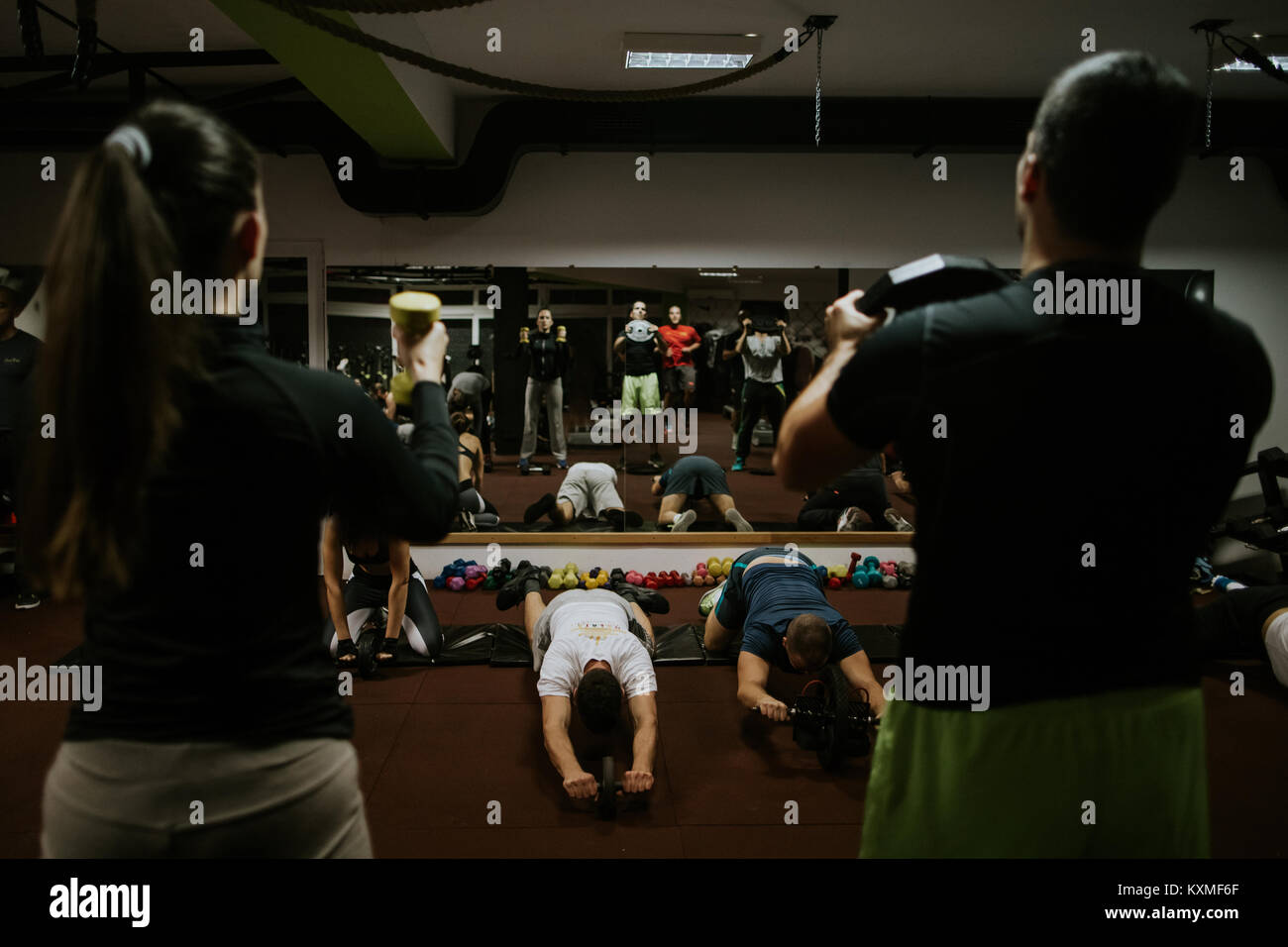 Crossfit group training workout indoors. Group fitness workout with ...