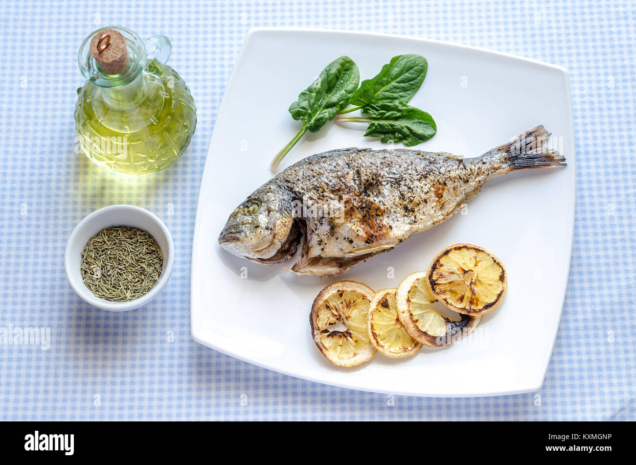 Grilled dorada fish with lemon and spinach Stock Photo - Alamy