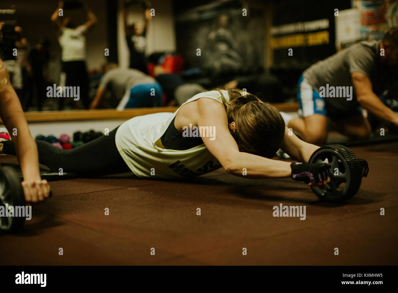 Crossfit wheel Ab Roller. Group training workout Stock Photo - Alamy