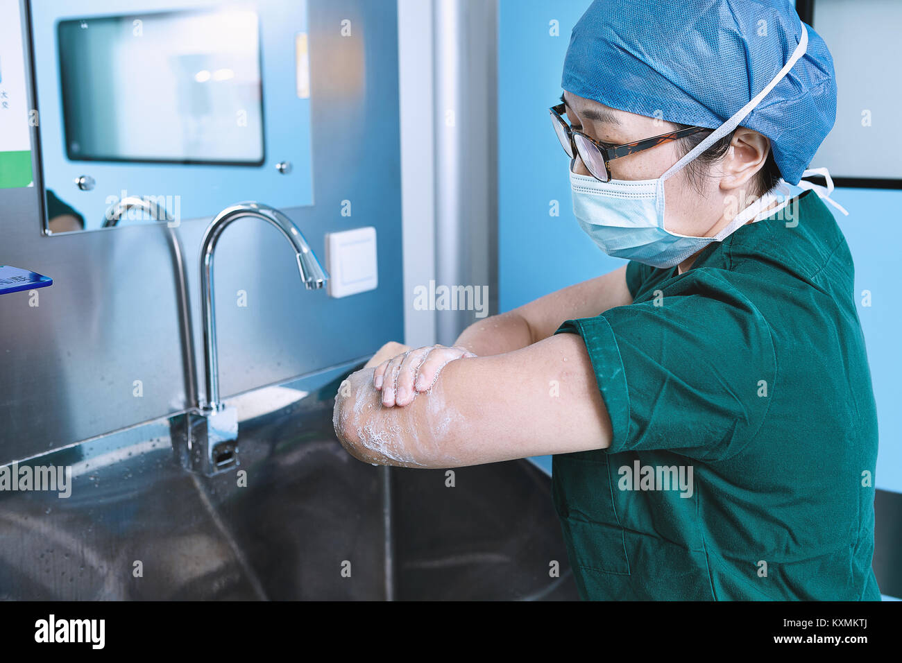 Theatre nurse washing arms in maternity ward operating theatre Stock ...