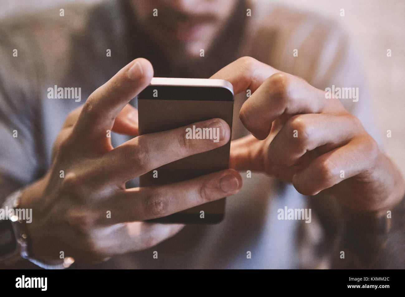 Hands of young man holding smartphone,close up Stock Photo - Alamy