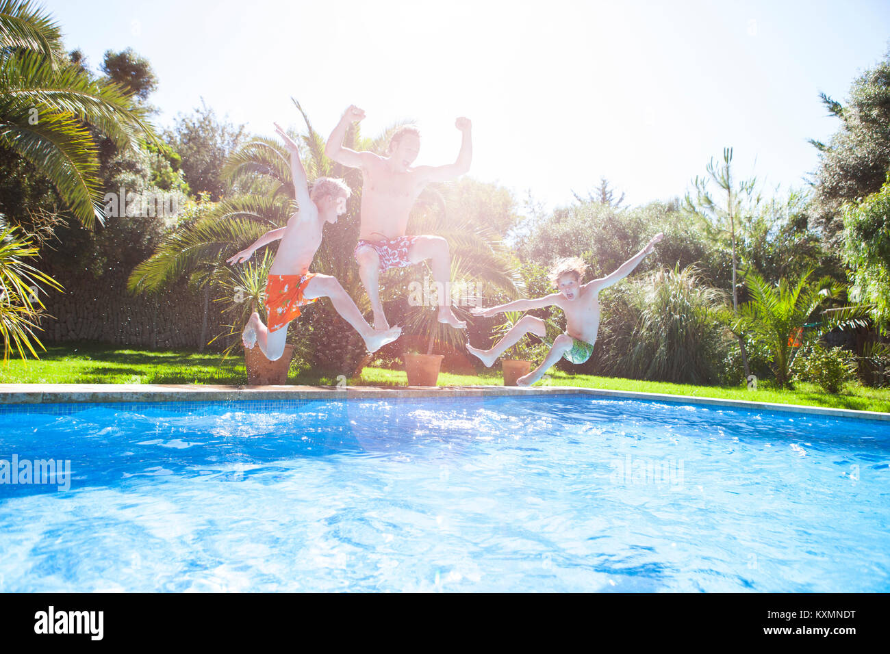 Three people jumping swimming pool hi-res stock photography and images ...