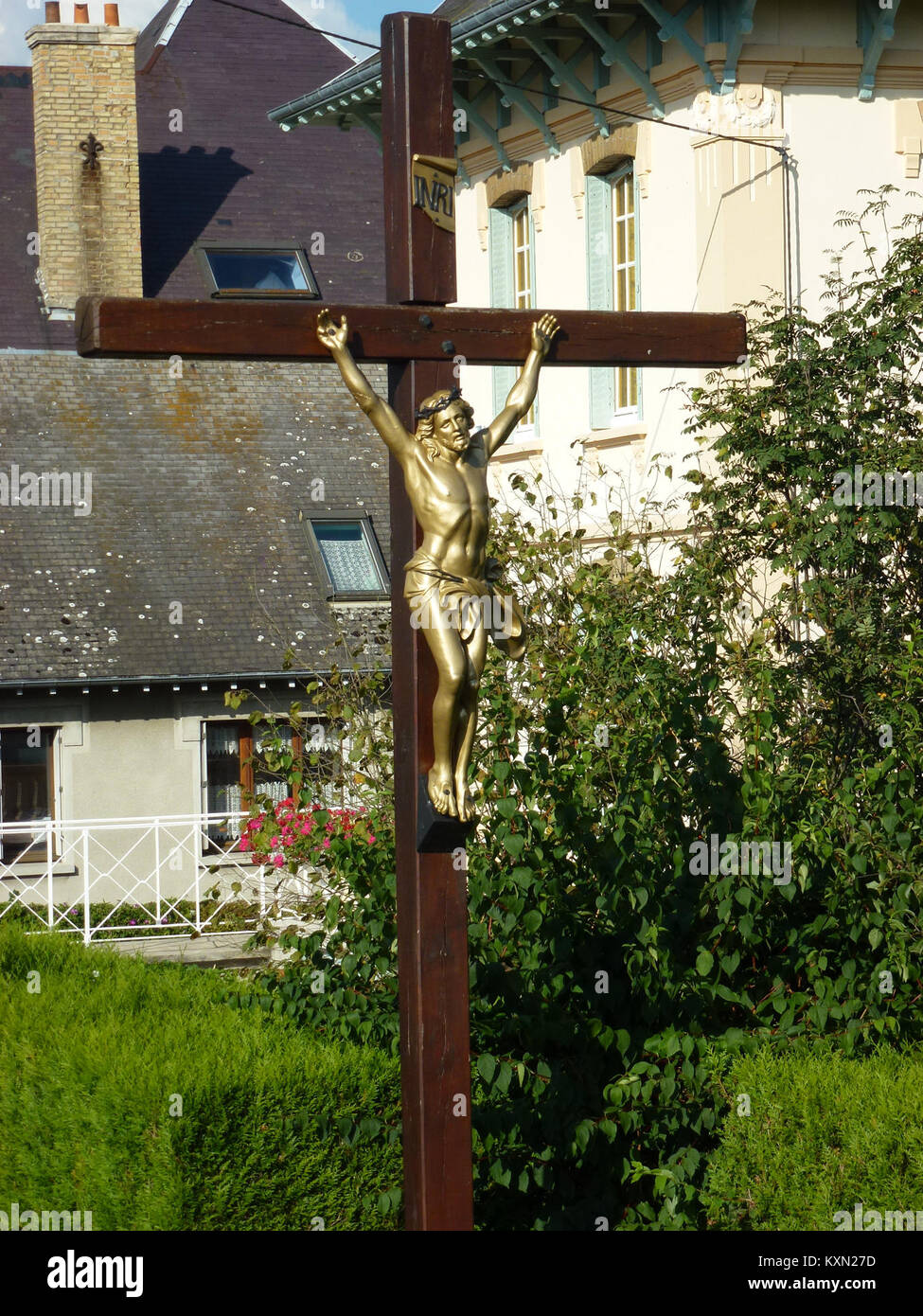 This photograph shows a roadside cross located near a bridge in Attigny ...