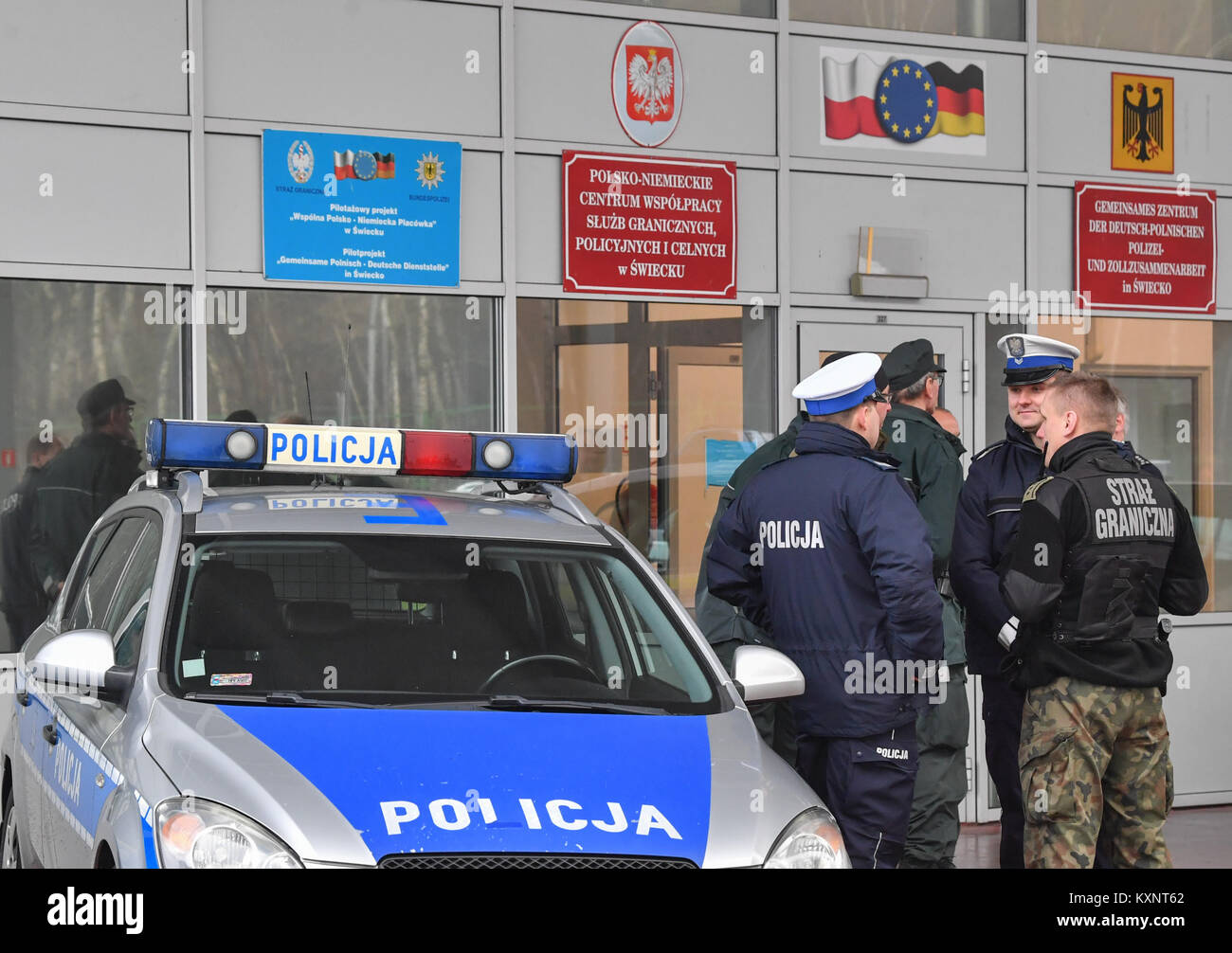 Polish police officers and border patrols stand in front of the ...