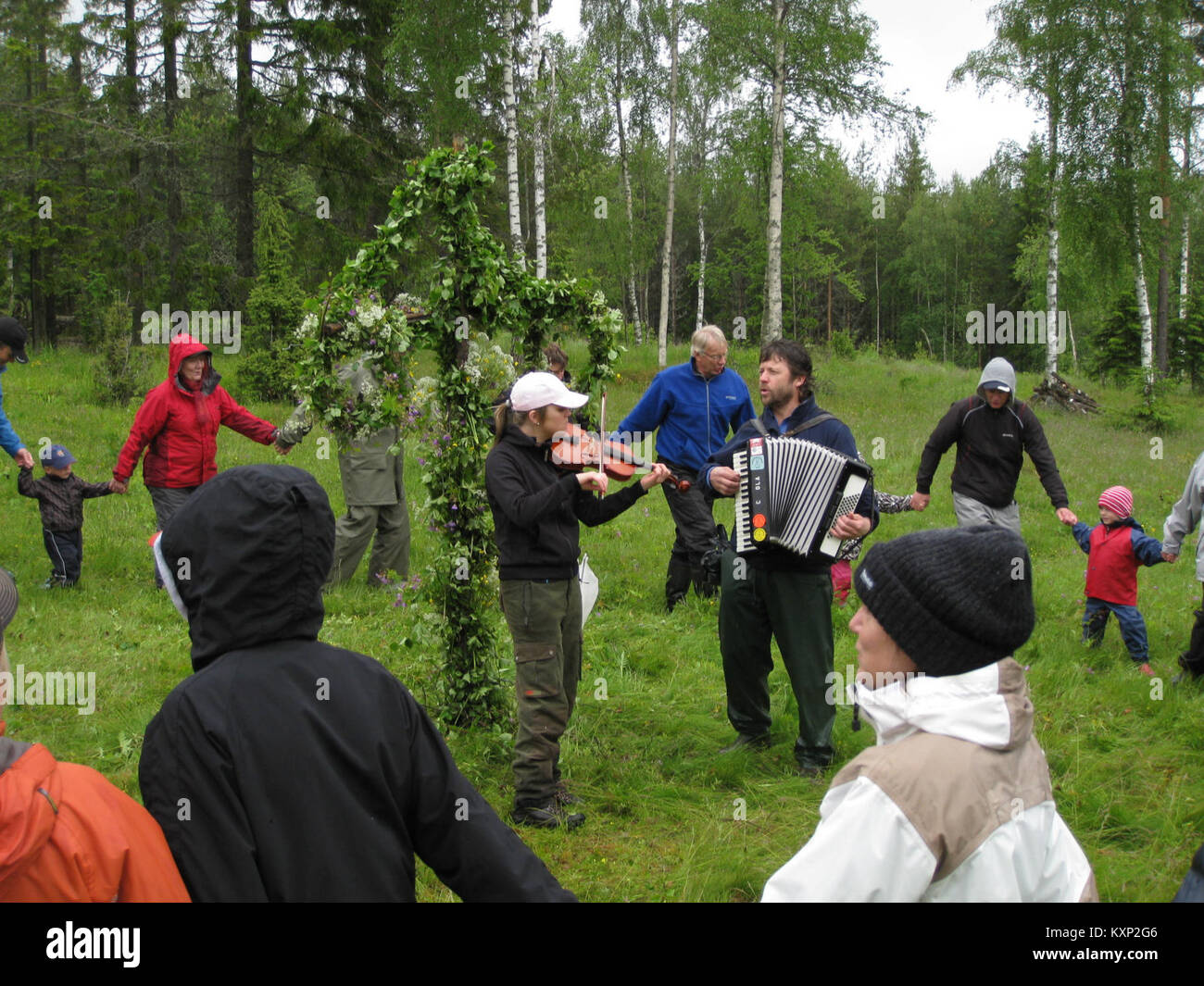 This photograph captures a traditional Swedish dance around a maypole ...