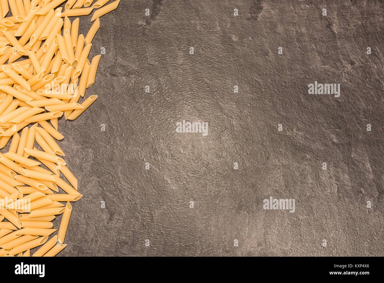 Penne Rigate macaroni pasta on grey working surface Stock Photo - Alamy