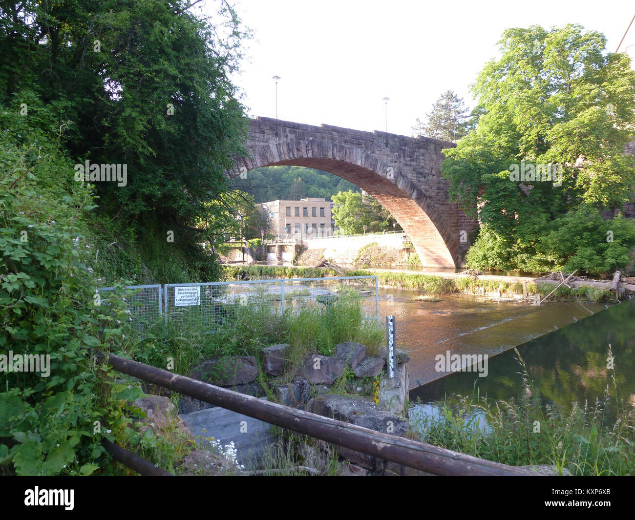 The photograph shows Bogenbrücke in Dillweißenstein, an arched stone ...