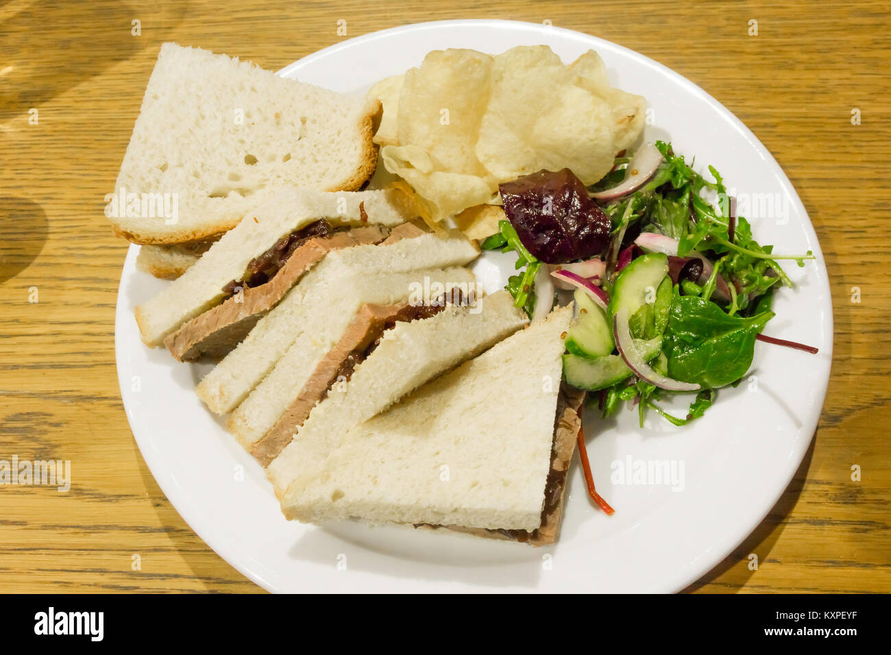 Lunchtime snack cold lean roast beef and red onion chutney sandwich in ...