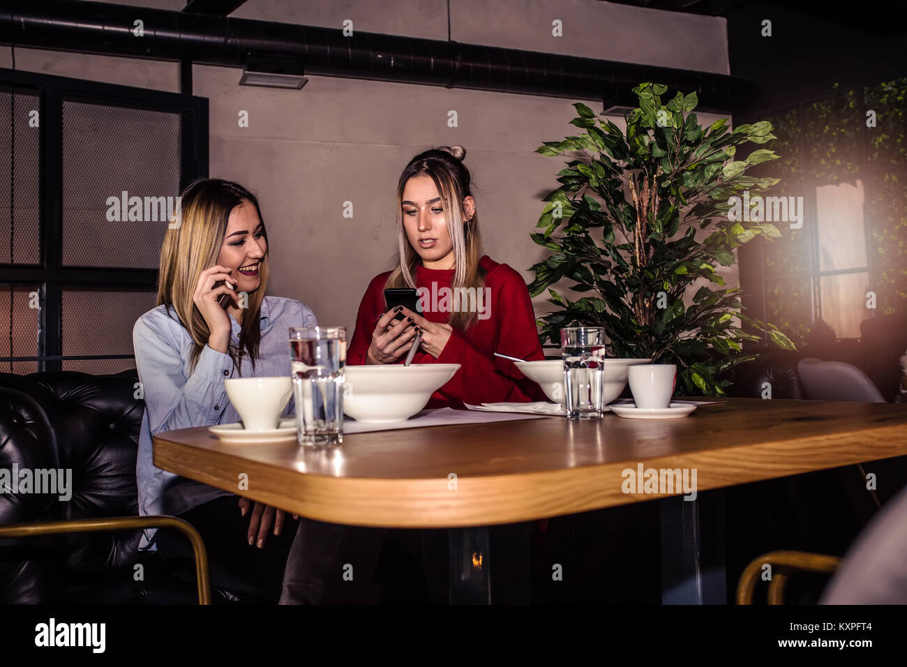 Female Friends Having Lunch Together At The Restaurant. Two young women ...