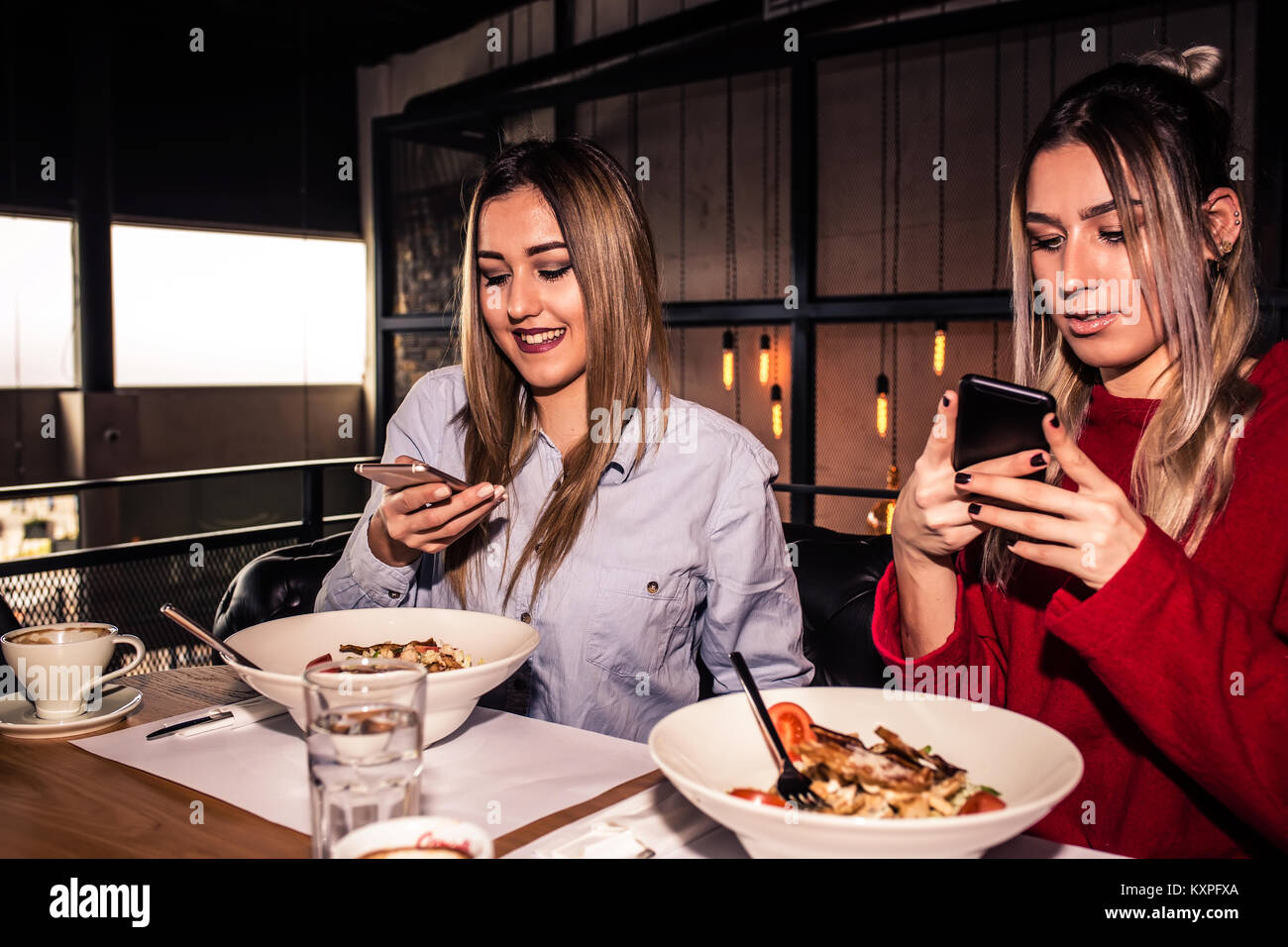 Female Friends Having Lunch Together At The Restaurant. Two young women ...