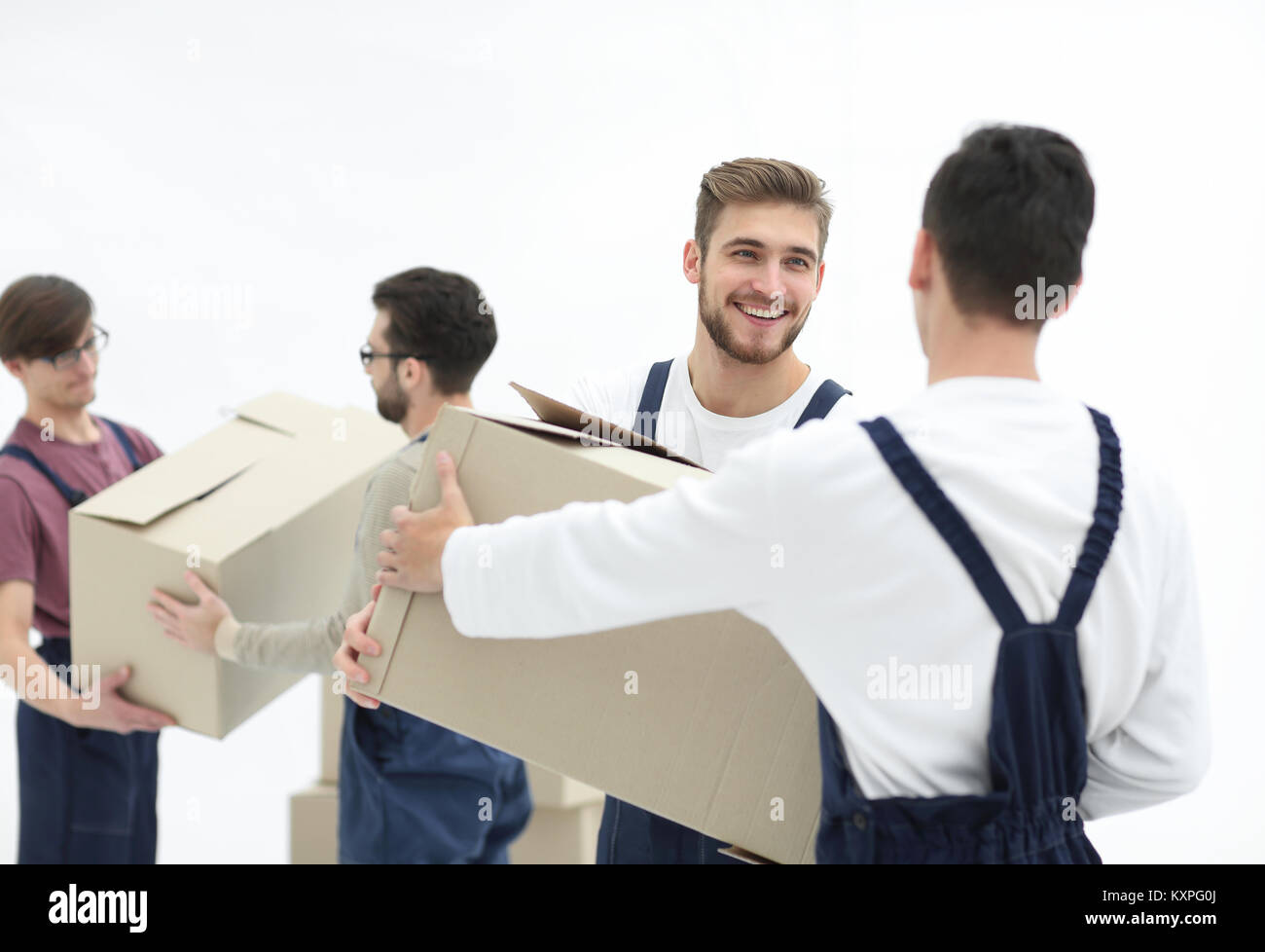 Delivery men with cardboard boxes on white background Stock Photo - Alamy