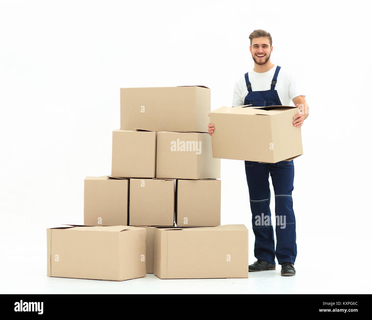 Young man carrying a box to the pile of boxes Stock Photo - Alamy