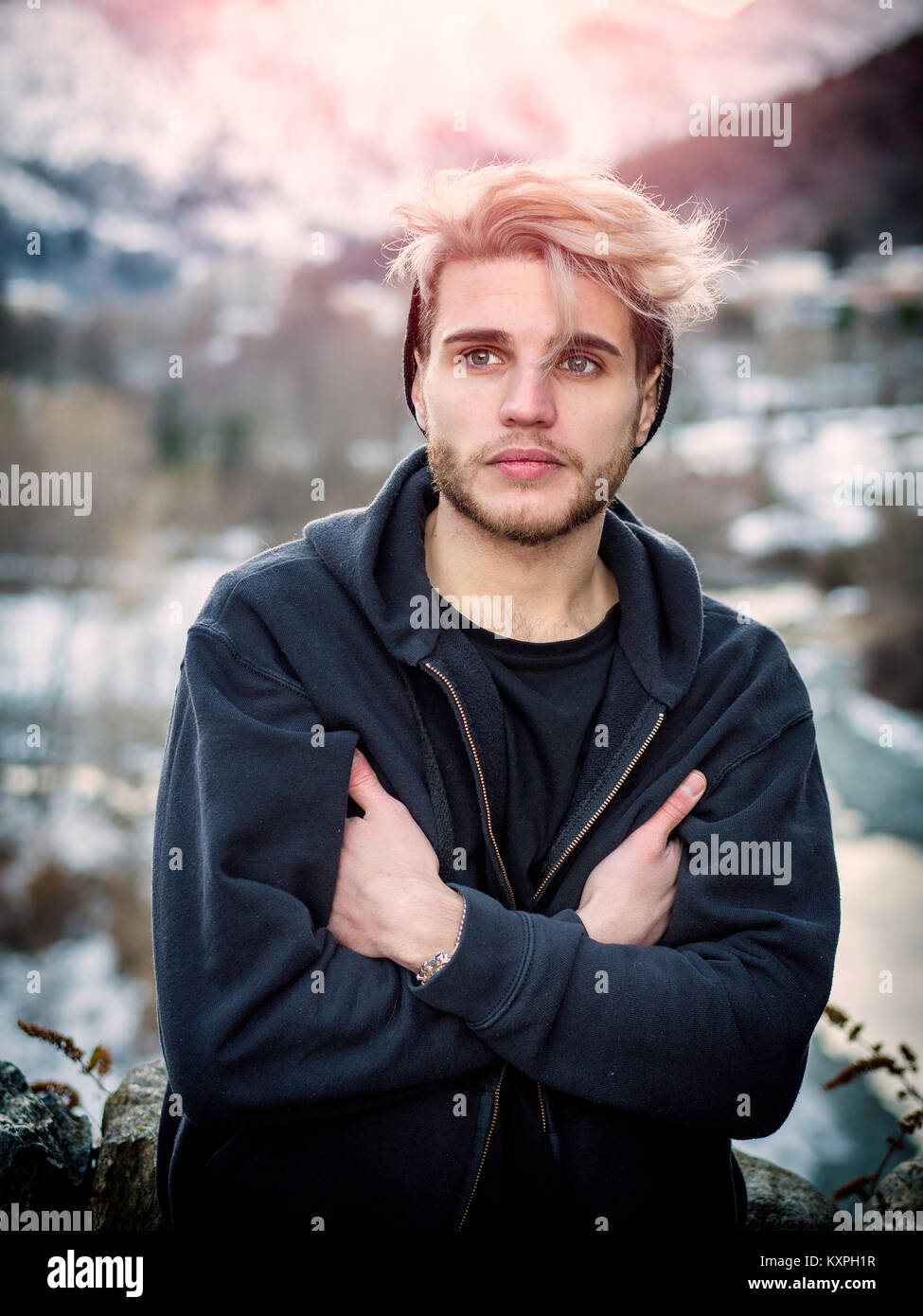 Handsome man in snow posing for camera Stock Photo - Alamy