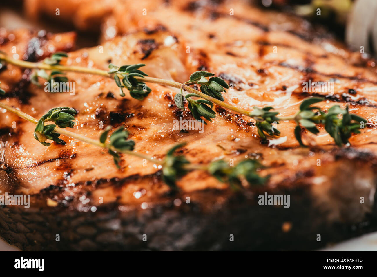 Close-up view of grilled salmon fish with thyme Stock Photo - Alamy