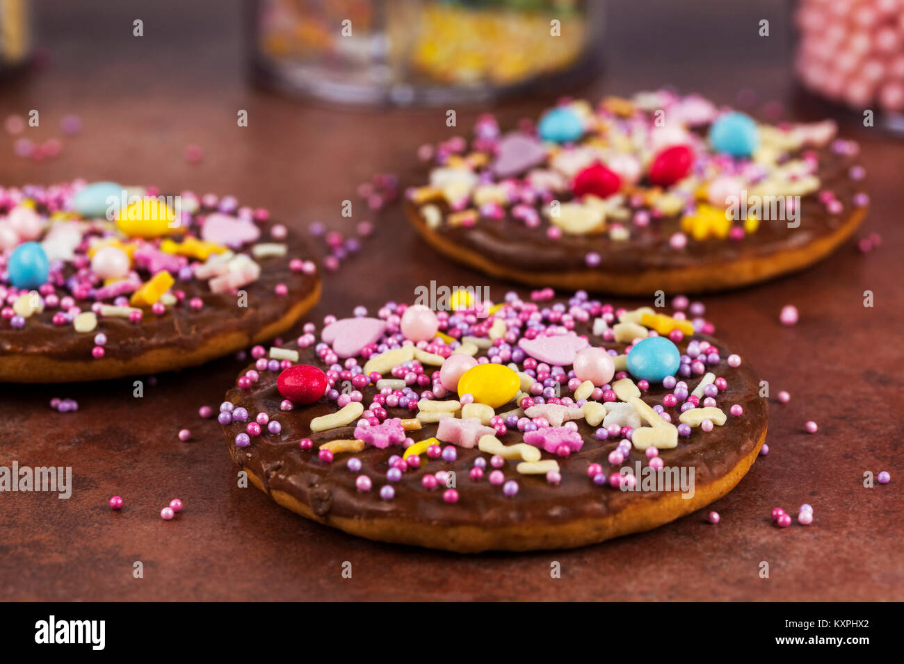 Freshly made chocolate biscuits sprinkled with various colourful candy ...
