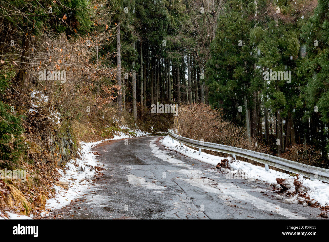A snowy mountain road winds through Nagano Prefecture, Japan Stock ...