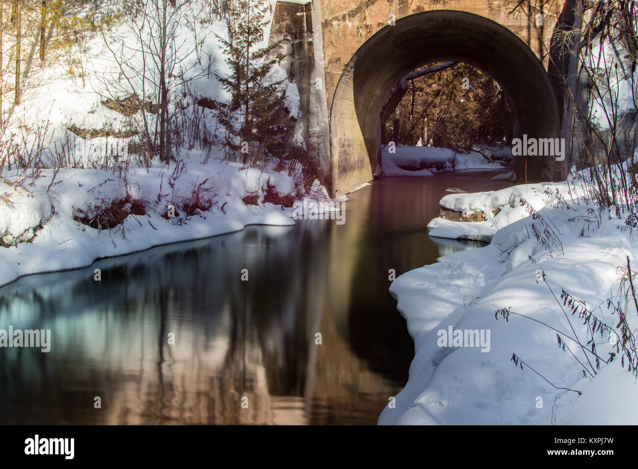 Snow And Ice Covered Creek In Winter Stock Photo - Alamy