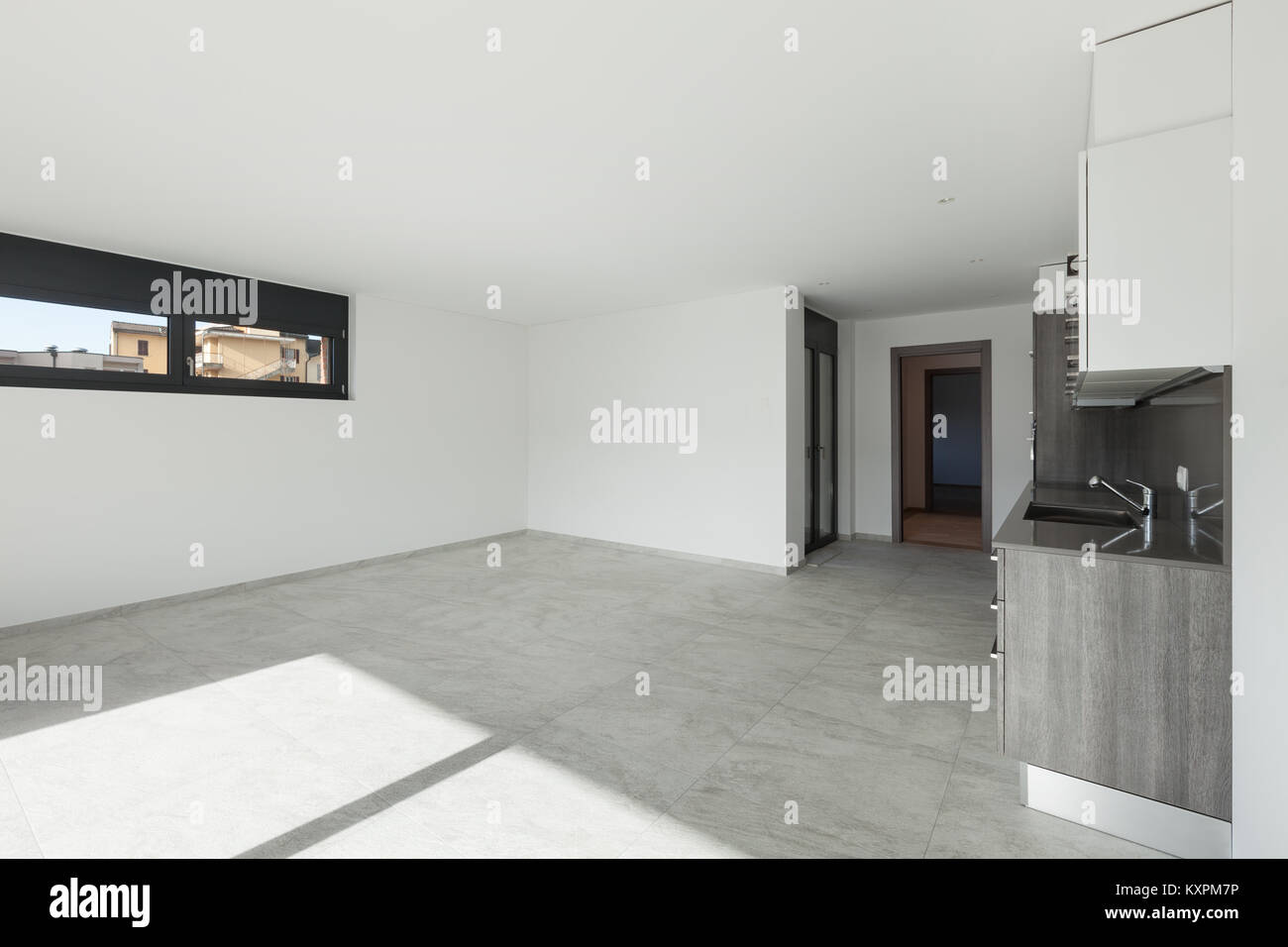 Interior of empty apartment, wide room with kitchen, tiled floor Stock ...