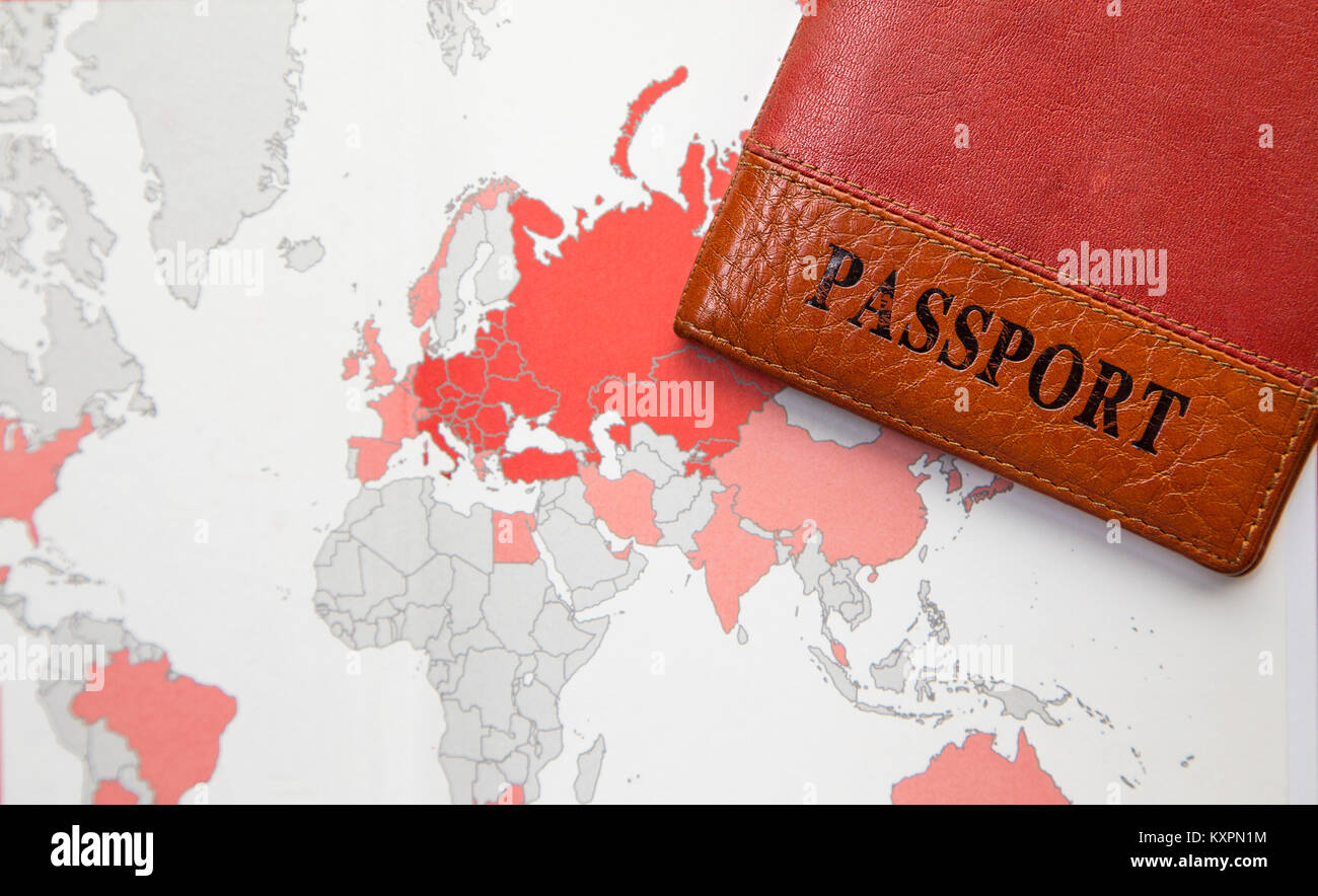 passport cover in orange on a background map of the world Stock Photo ...