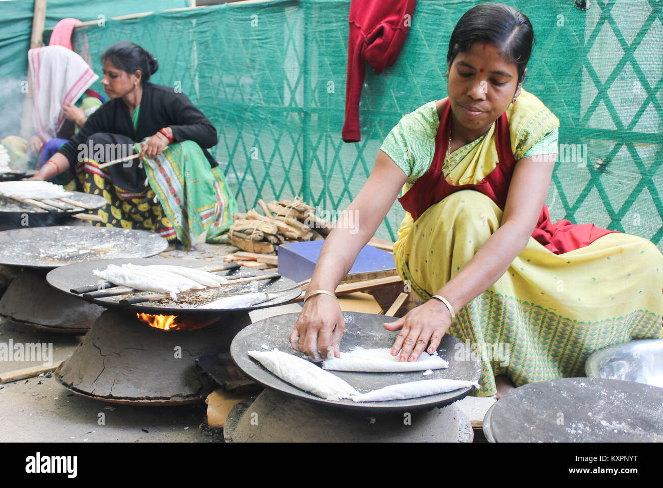 Assamese women preparingTraditional Assamese cake ( Bora Pitha) ahead ...