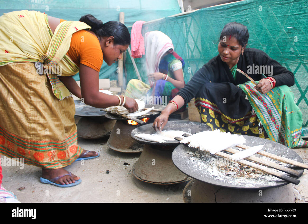 Assamese women preparingTraditional Assamese cake ( Bora Pitha) ahead ...