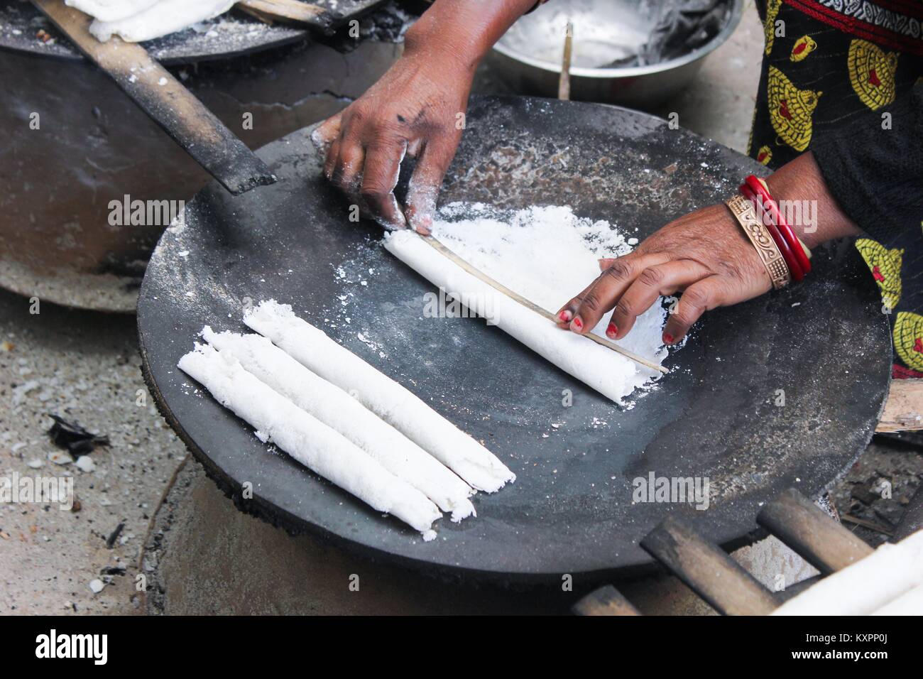 Assamese women preparingTraditional Assamese cake ( Bora Pitha) ahead ...