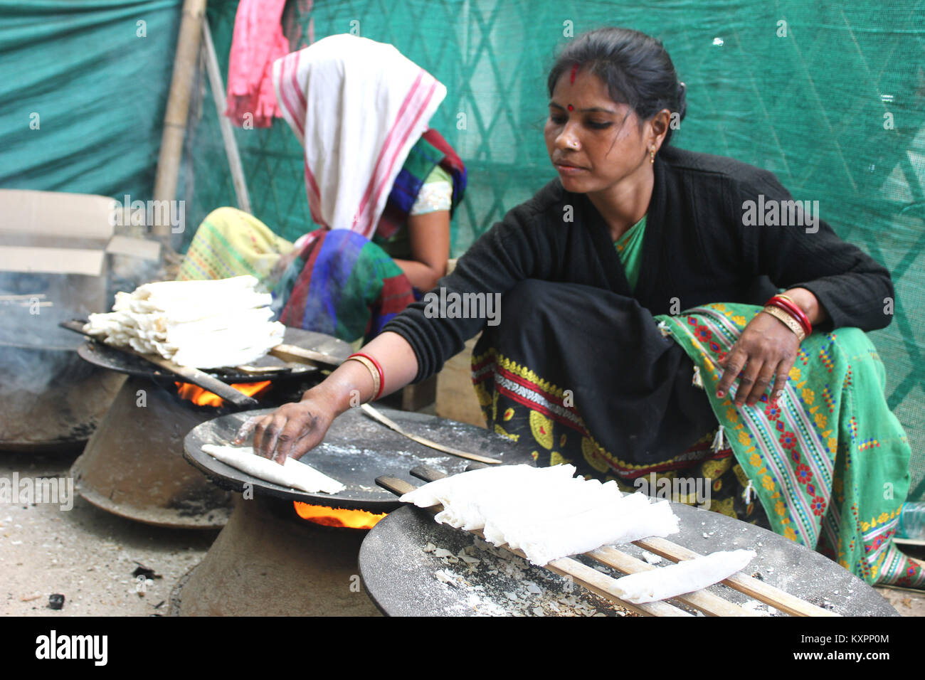 Assamese women preparingTraditional Assamese cake ( Bora Pitha) ahead ...