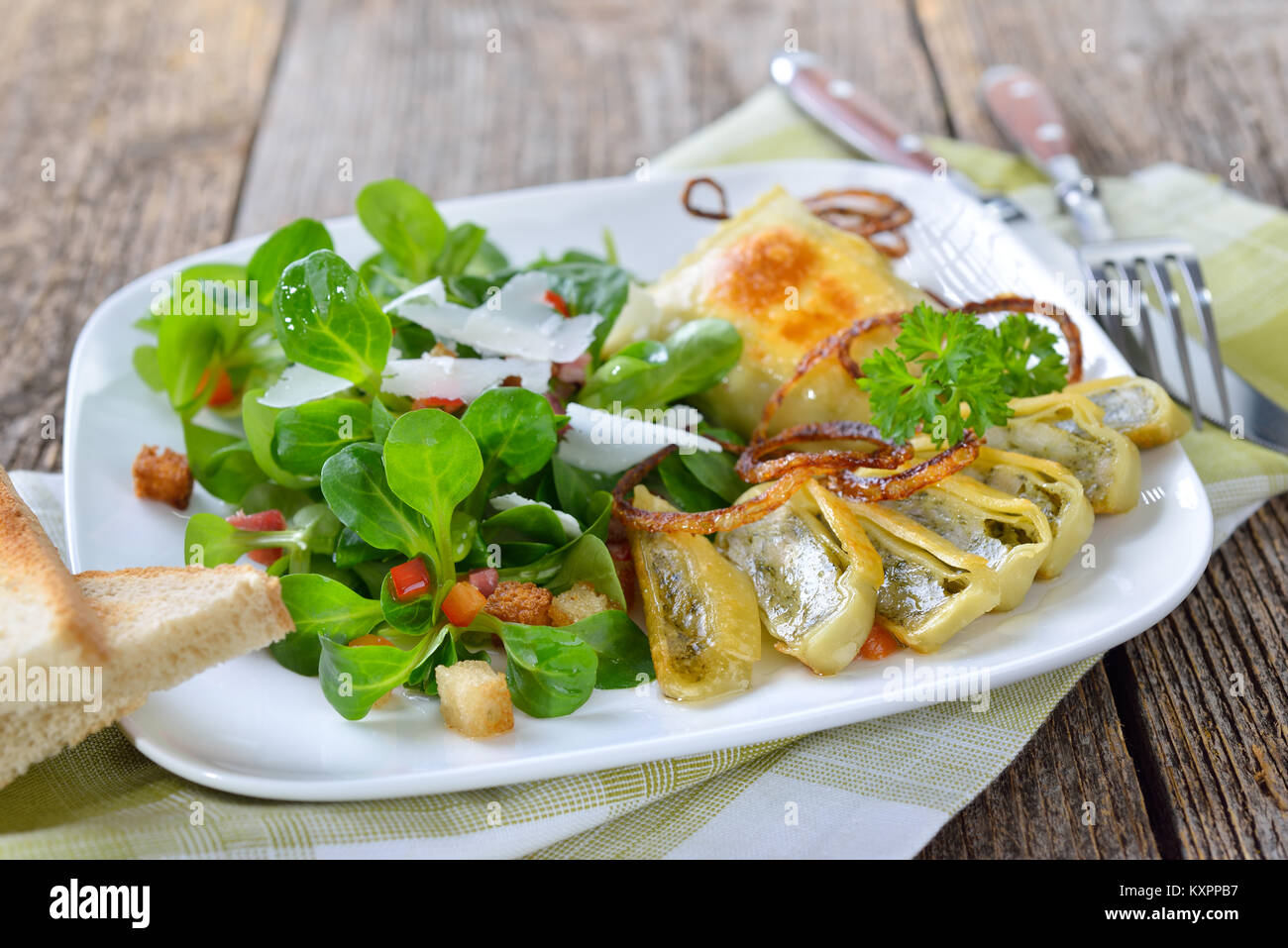 Fried Swabian meat ravioli (so called 'Maultaschen') served with corn ...