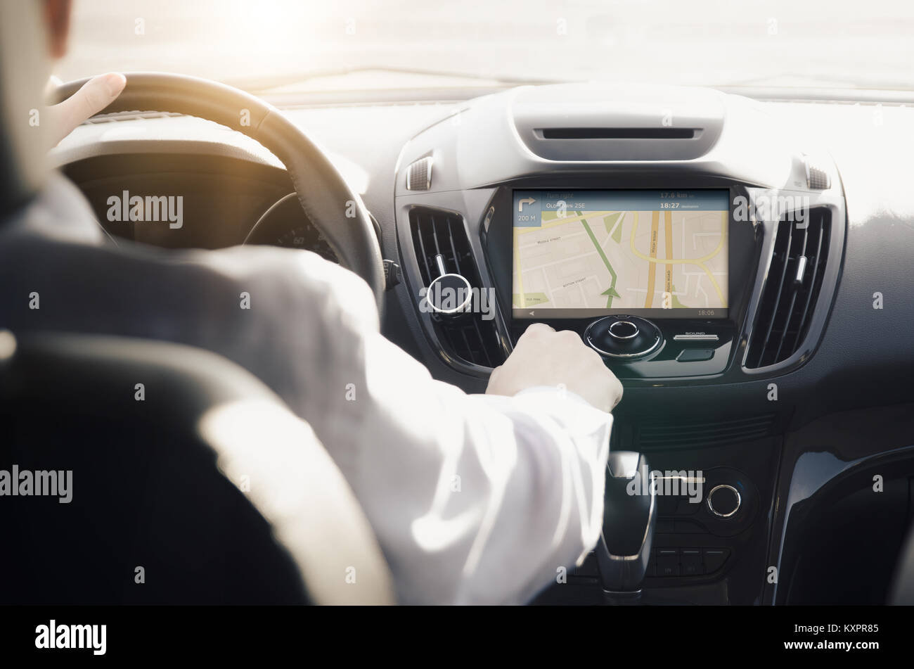 GPS navigation system. Person driving a car with satellite navigation ... GPS navigation system. Person driving a car with satellite navigation ...