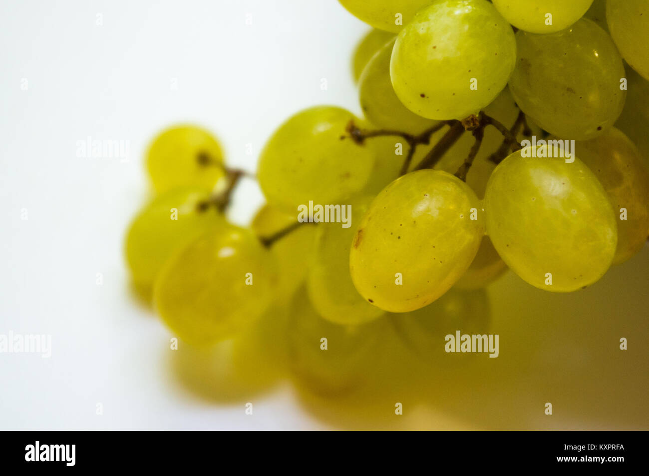 Large grapes cluster amber color on white background Stock Photo - Alamy