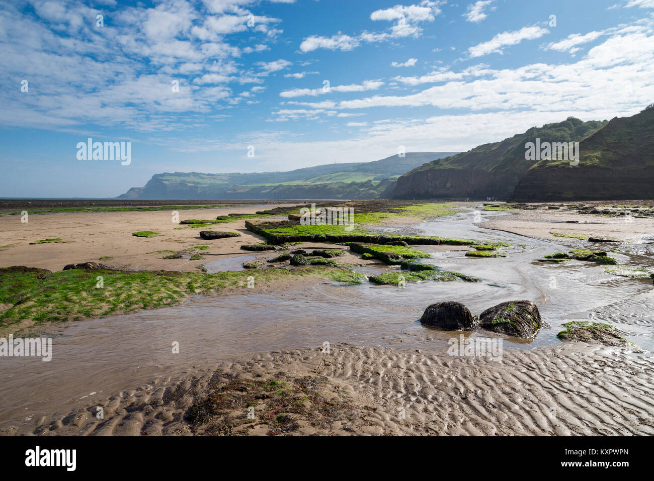 Beautiful beach and high cliffs at Robin Hood's Bay on the coast of ...