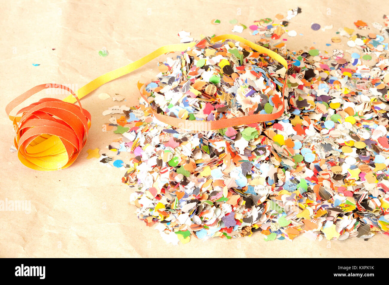 Carnival background, a streamers roll on a pile of confetti Stock Photo ...