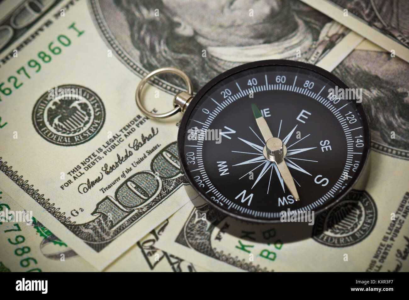 U.S. Dollar currencies with a compass Stock Photo - Alamy