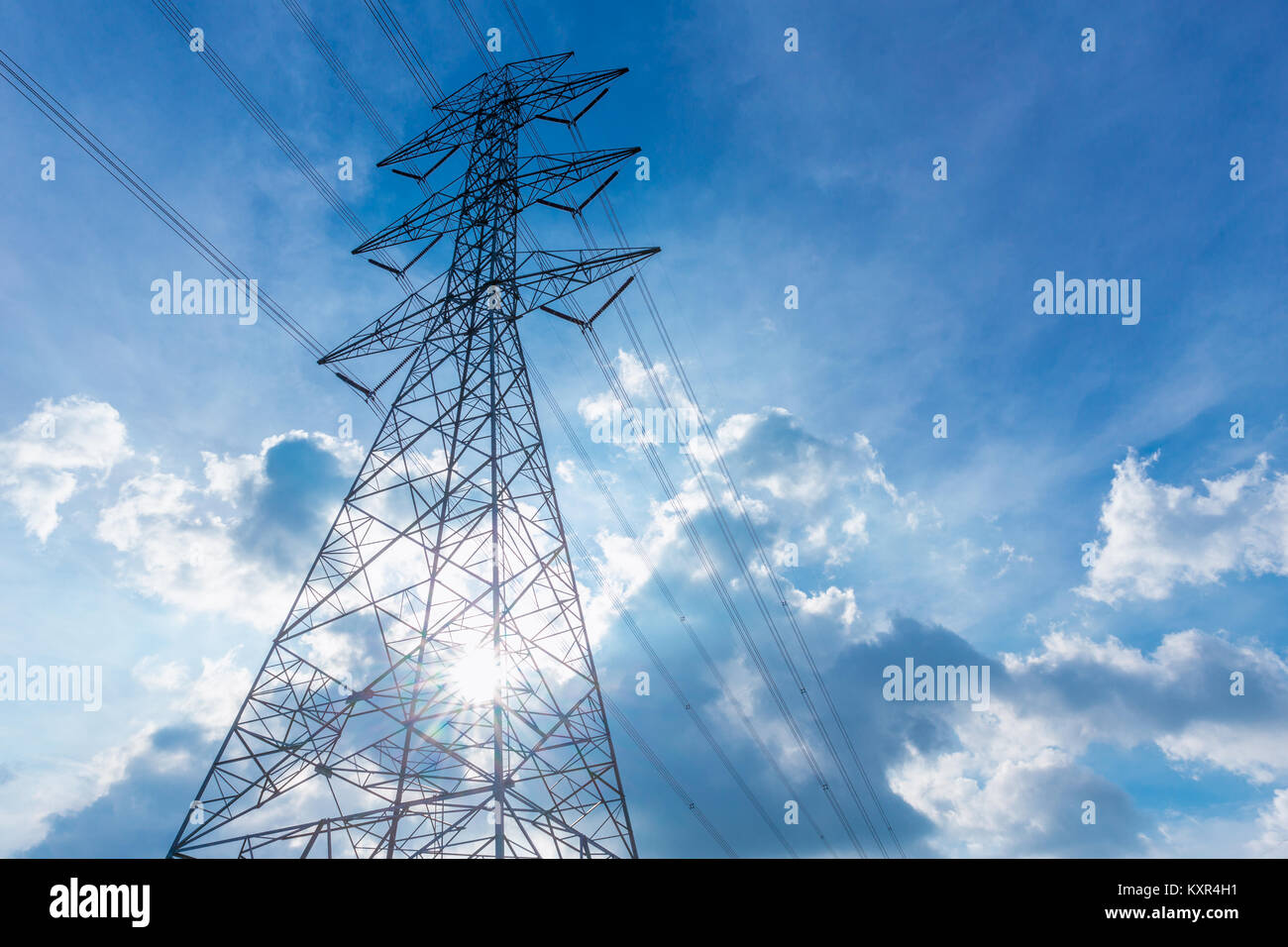 high voltage electricity power line silhouette with blue cloud sky ...