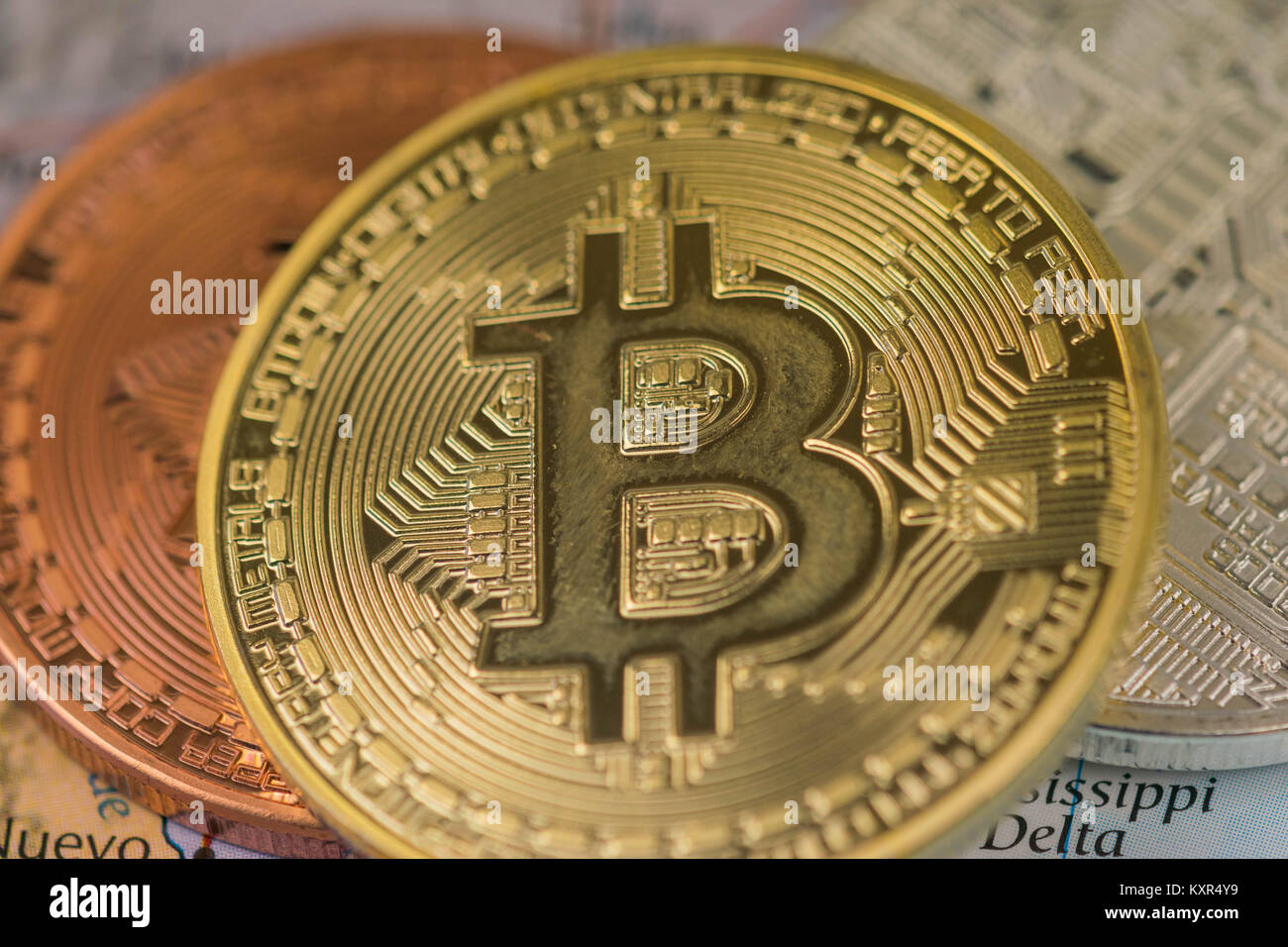 Golden Bitcoin Coin close up together with silver bitcoin and bronze ...
