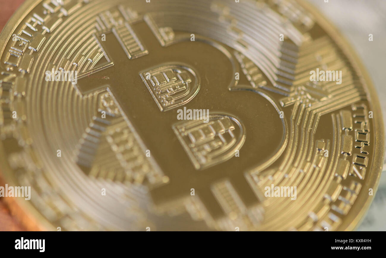 Golden Bitcoin Coin close up together with silver bitcoin and bronze ...