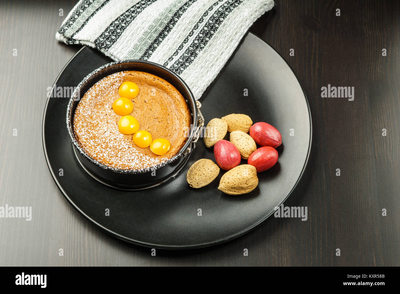 Homemade chocolate cheesecake in small springform pan on black plate ...