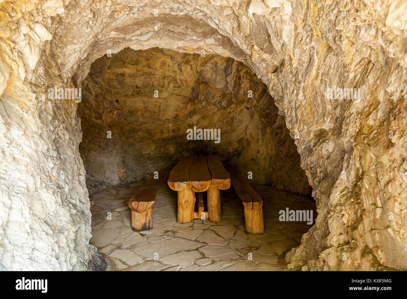 Wooden table with two benches in a stone room. Stone rooms of Georgia ...