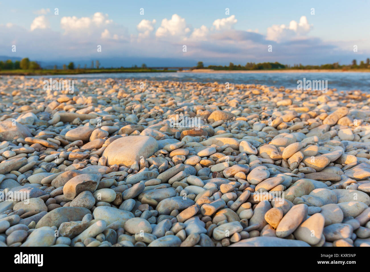 Top view background of rounded pebbles at the beach. Pebbles in the sun ...