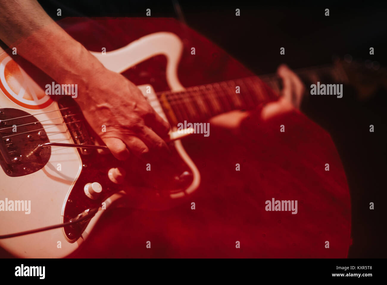 closeup rockstar on stage playing on electro guitar. Male guitarist ...