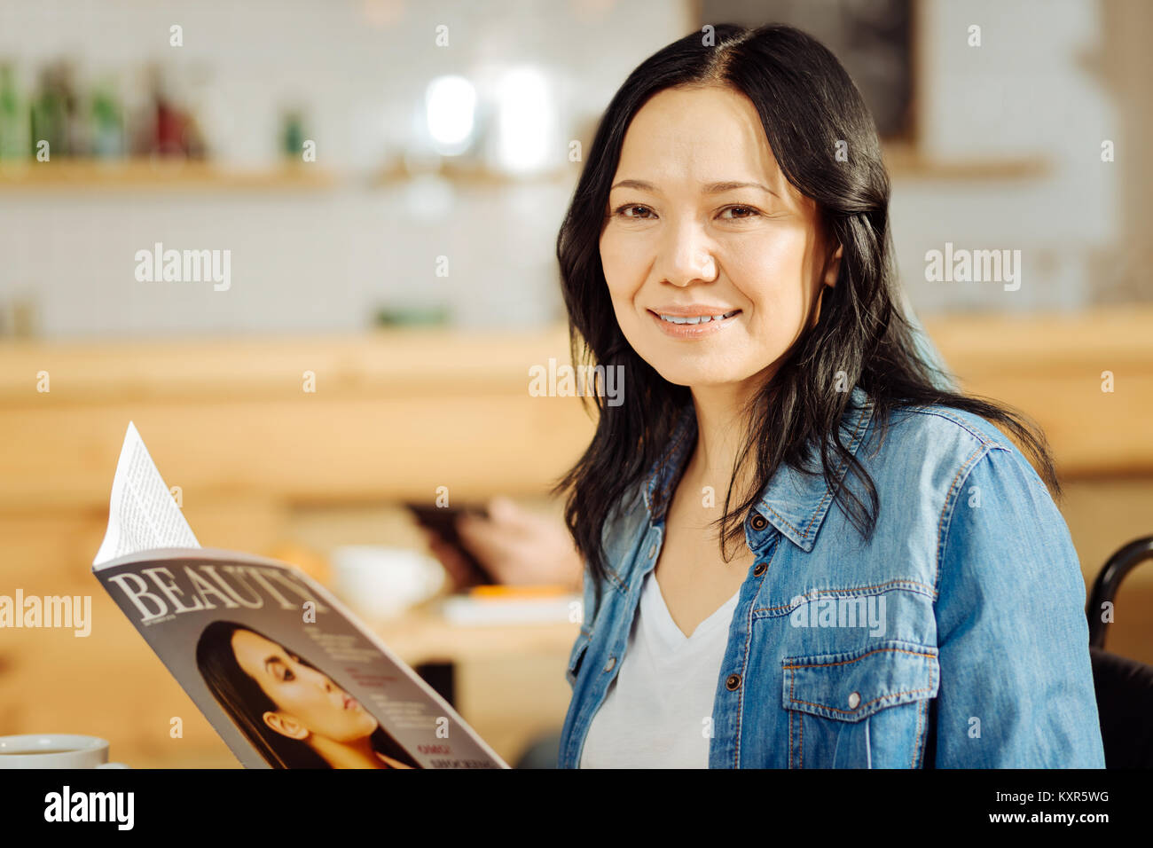 Alert woman relaxing with a magazine Stock Photo - Alamy